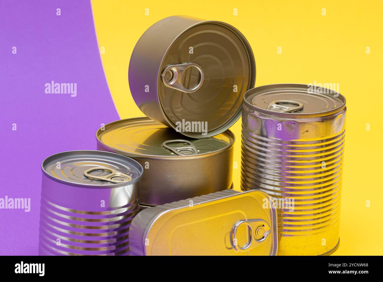 A Group of Stacked Tin Cans with Blank Edges on Split Yellow and Violet ...