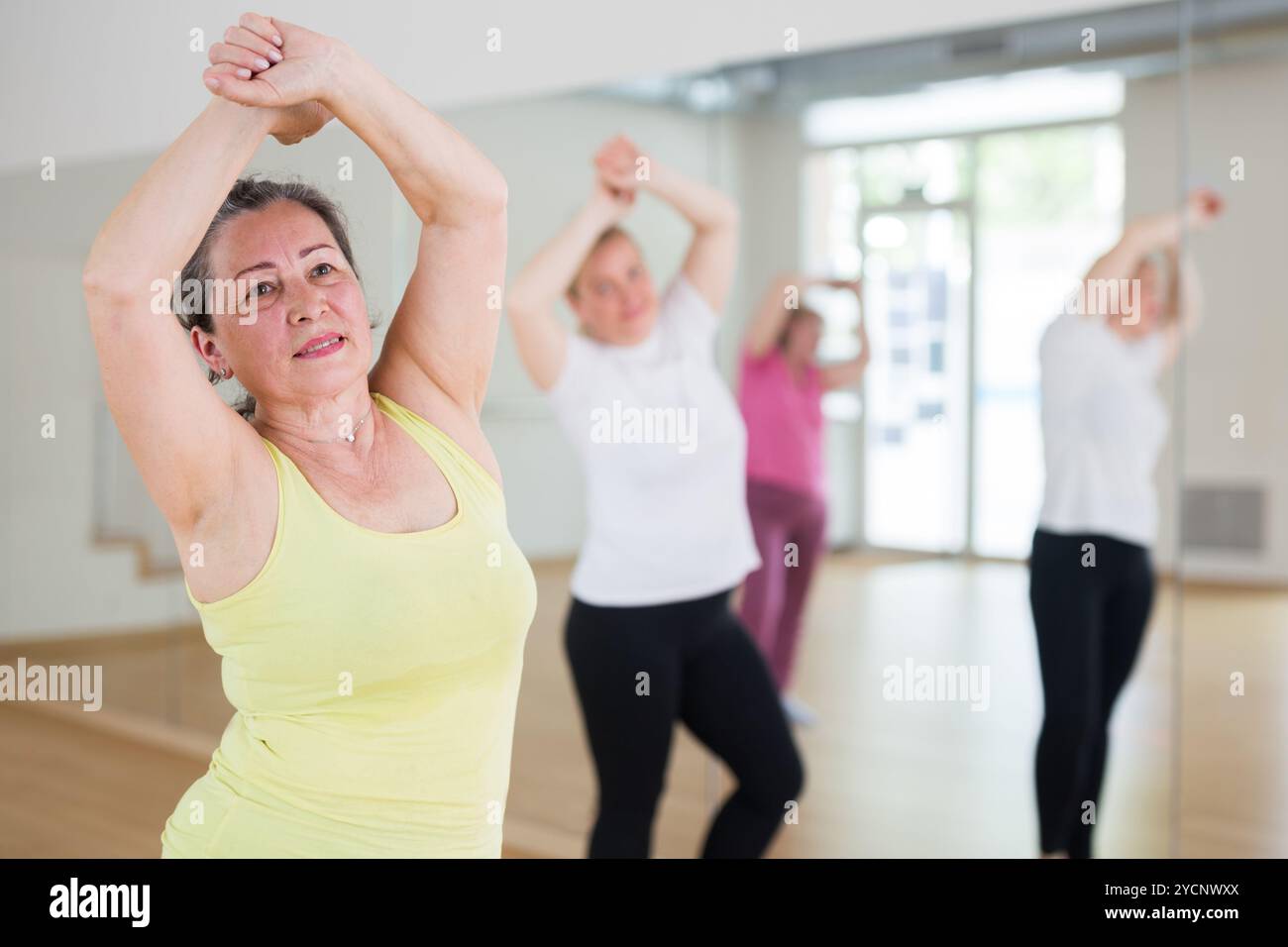 Mature women dancing aerobics at lesson in dance class Stock Photo - Alamy