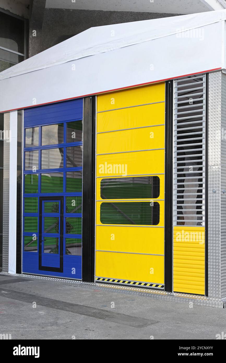 Tall doors at distribution warehouse building Stock Photo - Alamy