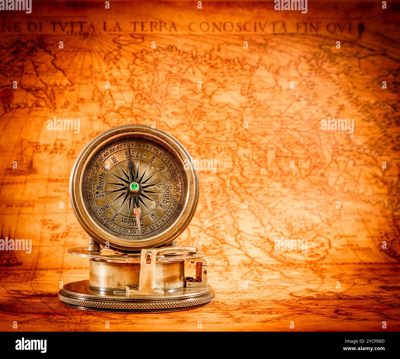 Vintage compass lies on an ancient world map Stock Photo - Alamy