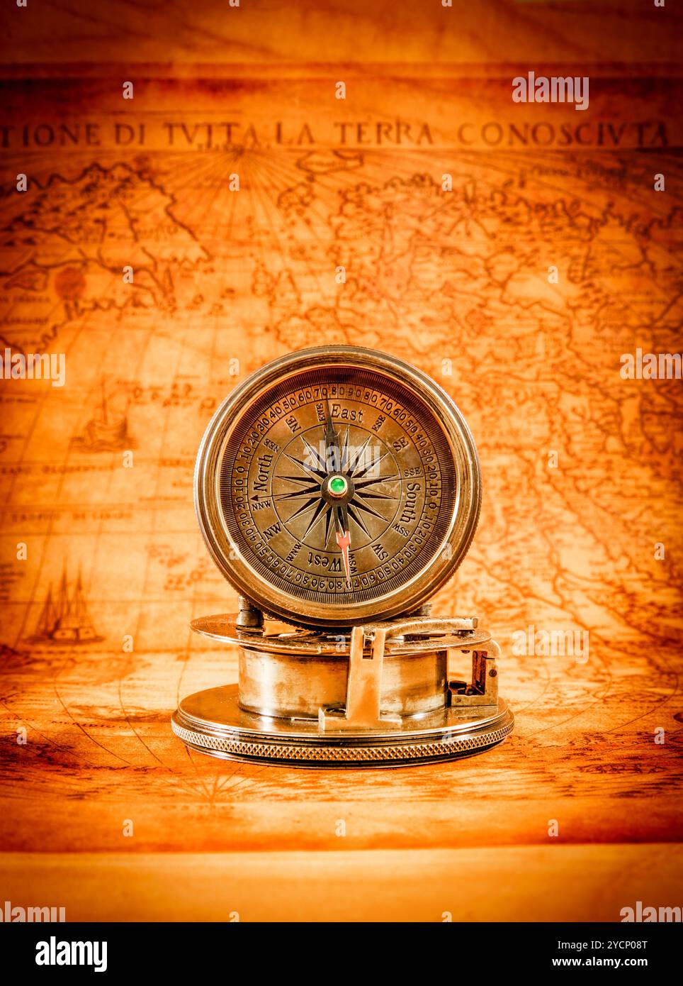 Vintage compass lies on an ancient world map Stock Photo - Alamy