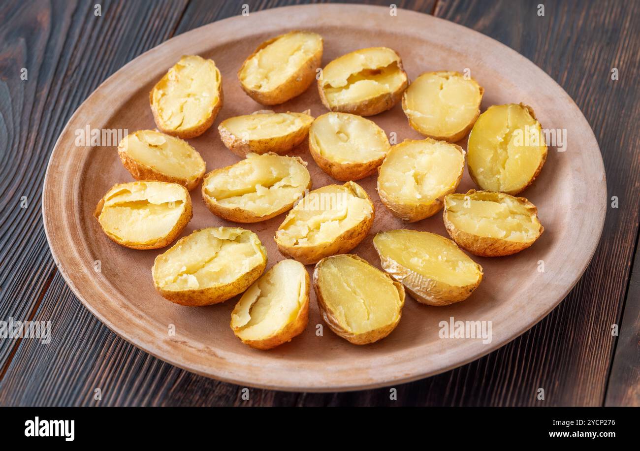 Plate with oven roasted crispy baby potatoes Stock Photo - Alamy