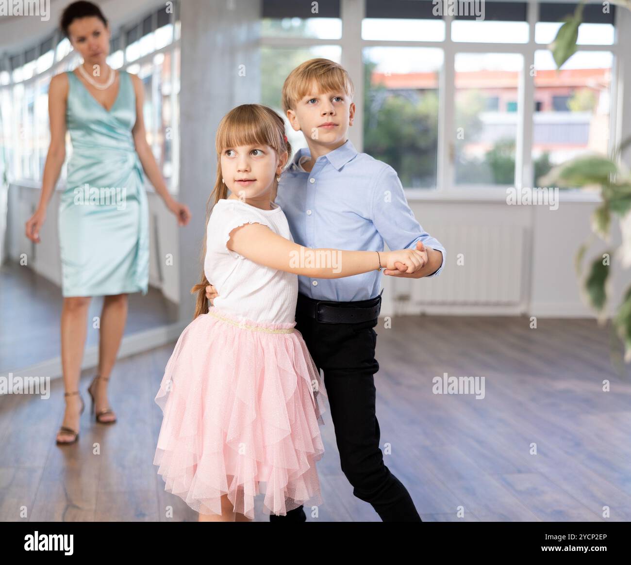 Boy and girl in pair train to dance contemporary vigorous waltz during ...