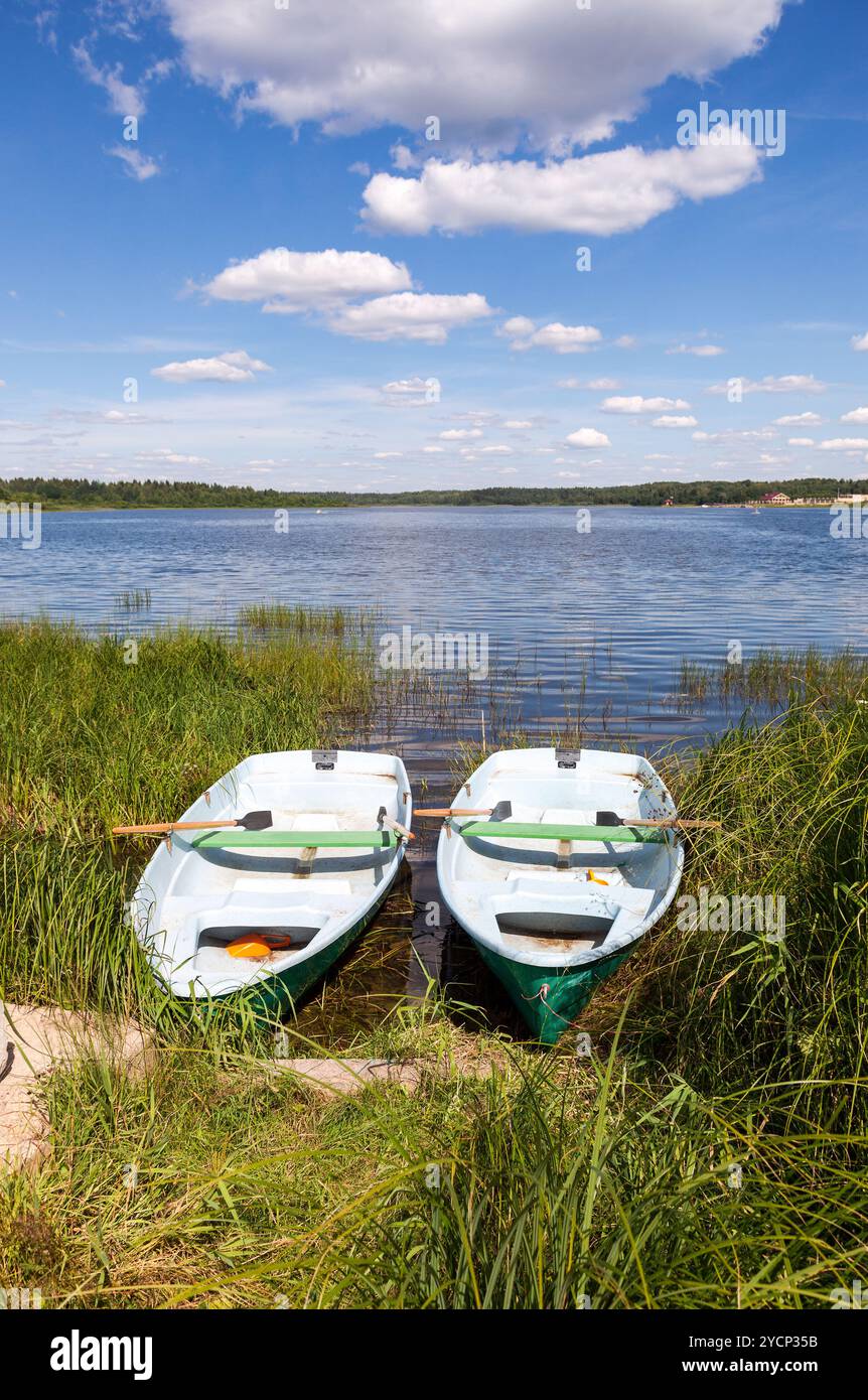 Lake scenery with two wooden boat in summertime Stock Photo - Alamy