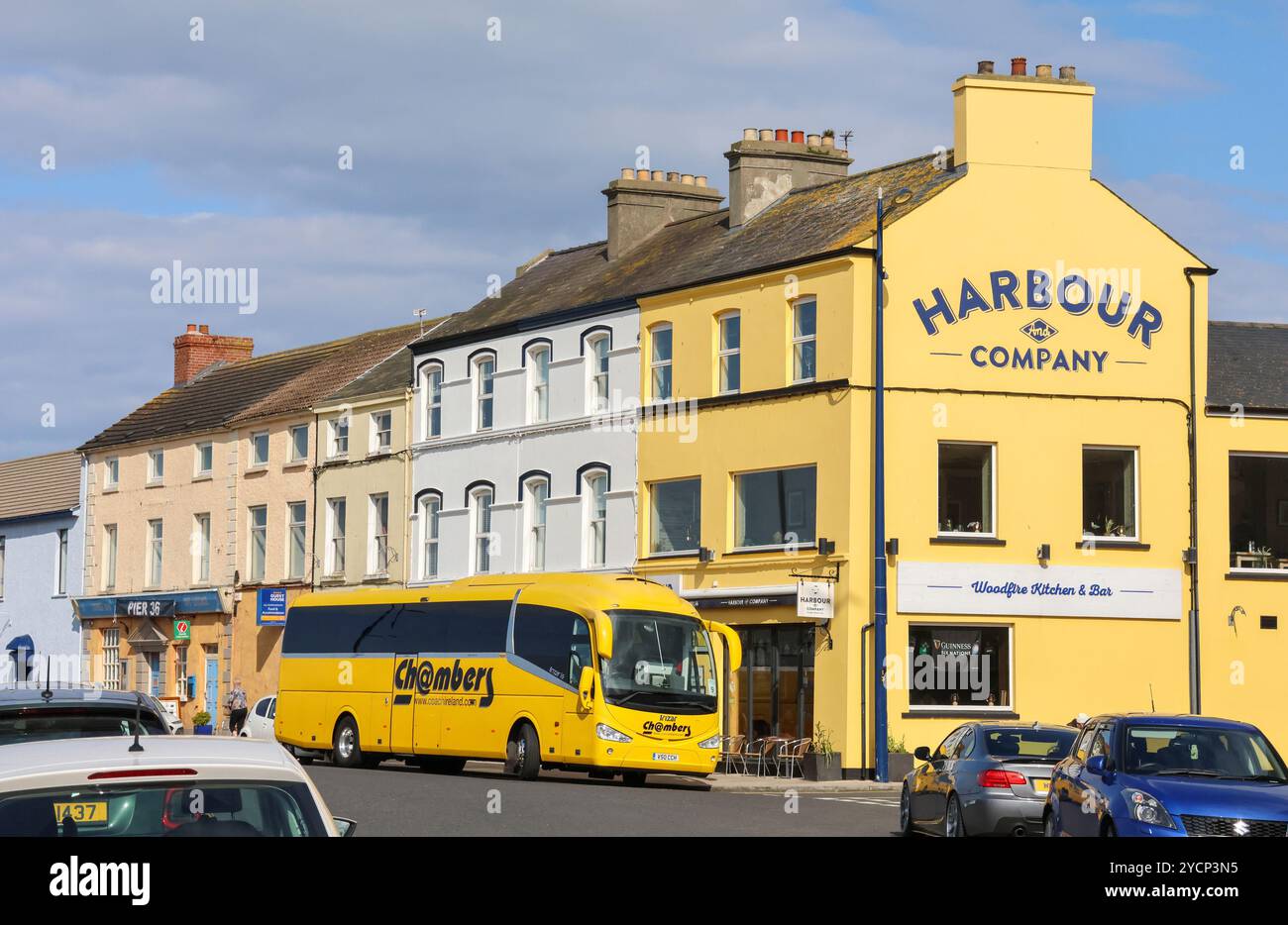 Tourist bus Northern Ireland outside coastal town restaurant Harbour ...