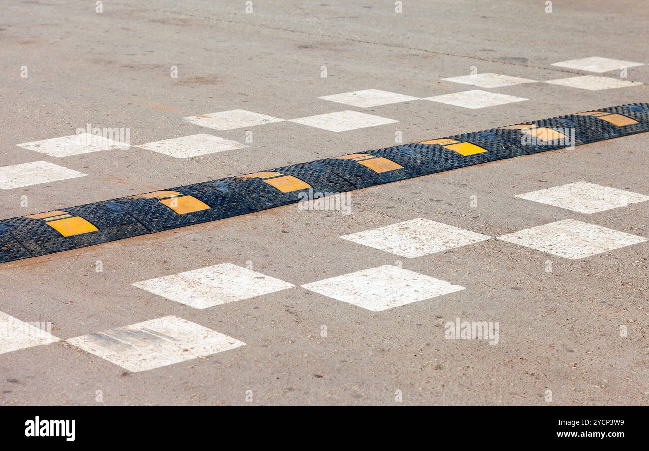 Traffic safety speed bump on an asphalt road Stock Photo - Alamy