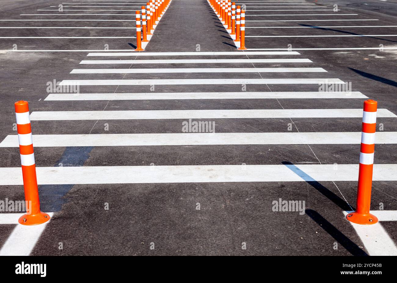 White traffic markings with a pedestrian crossing on a gray asphalt ...