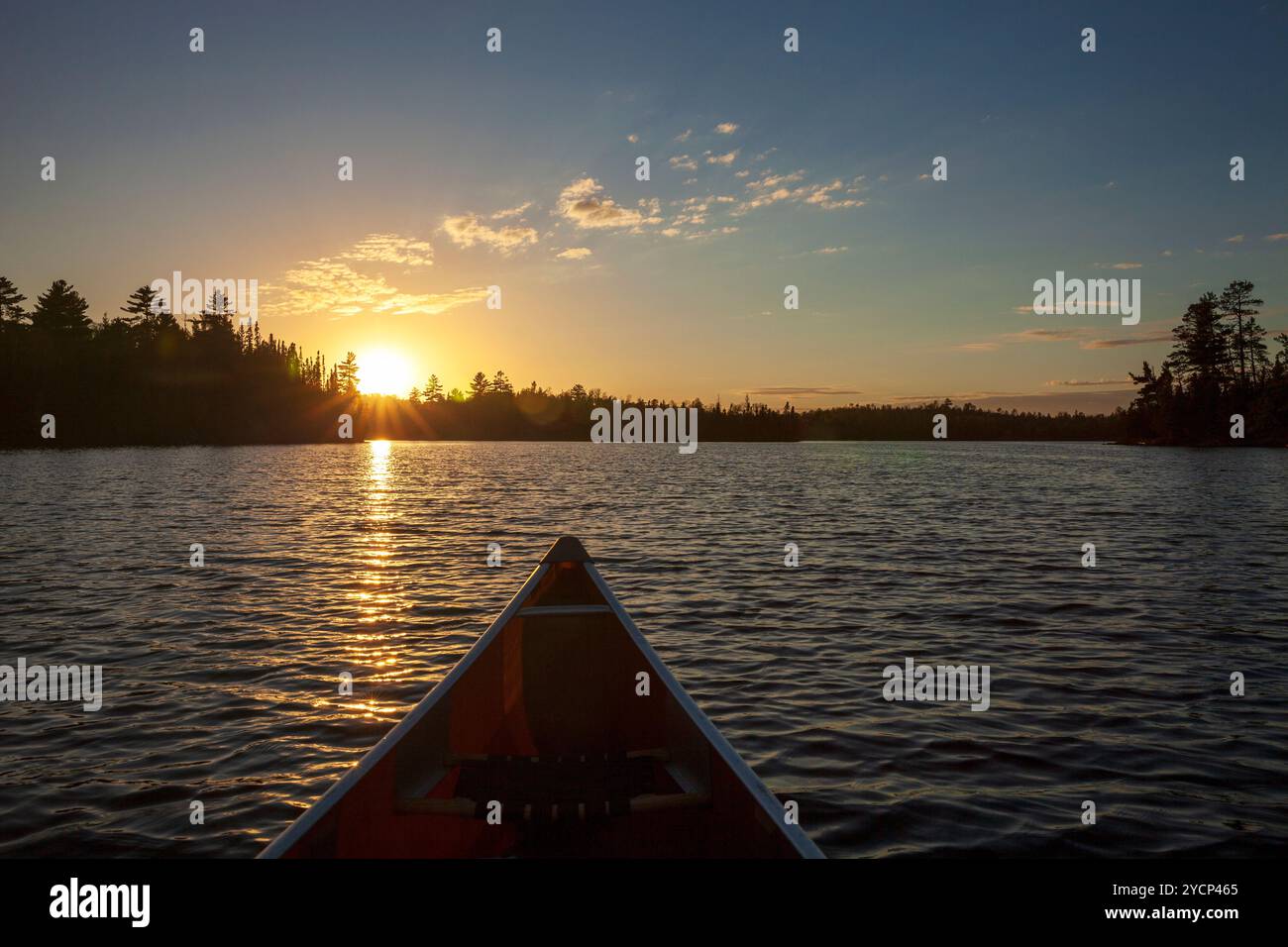 Canoe on a northern Minnesota boundary waters lake at sunset on an ...