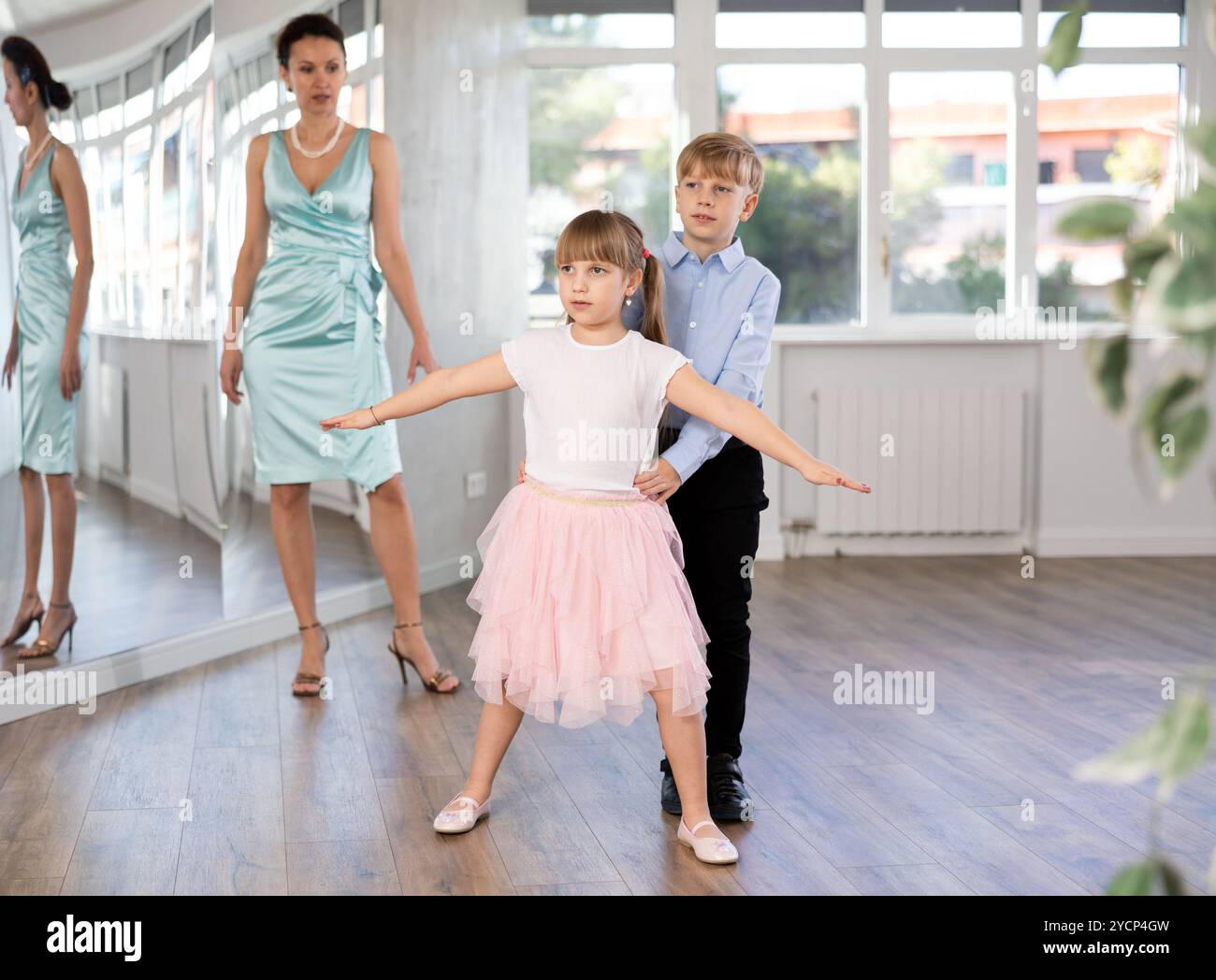 Boy and girl in pair train to dance contemporary vigorous waltz during ...