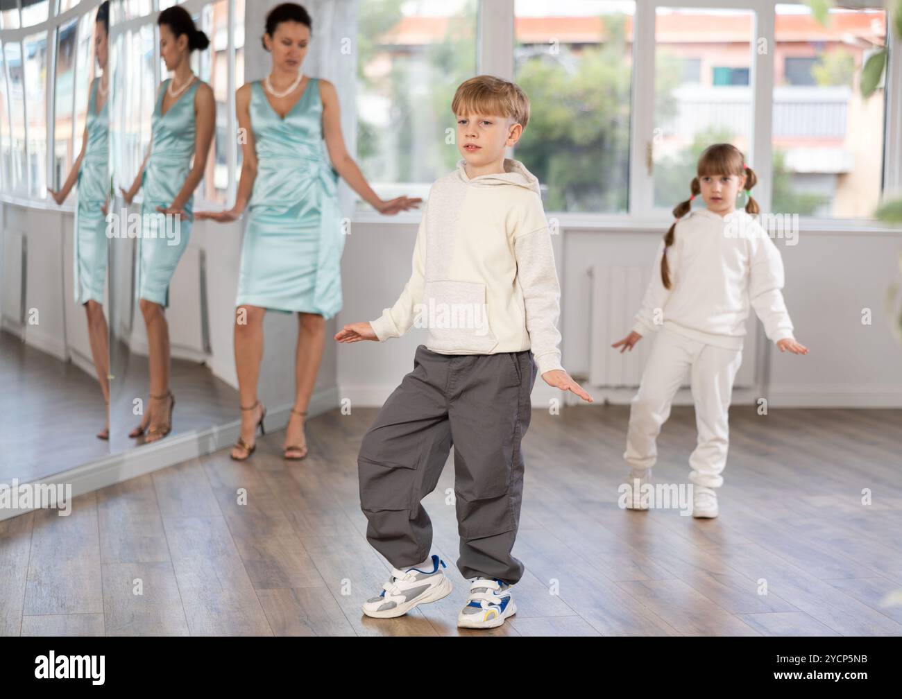 Tween boy mimicking comedic stroll of Charlie Chaplin during dance ...