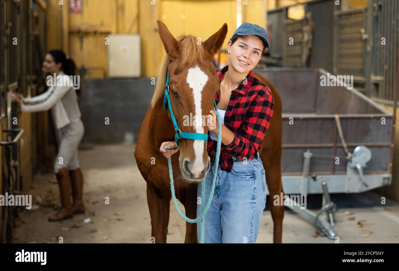 Young woman with horse in stable Stock Photo - Alamy