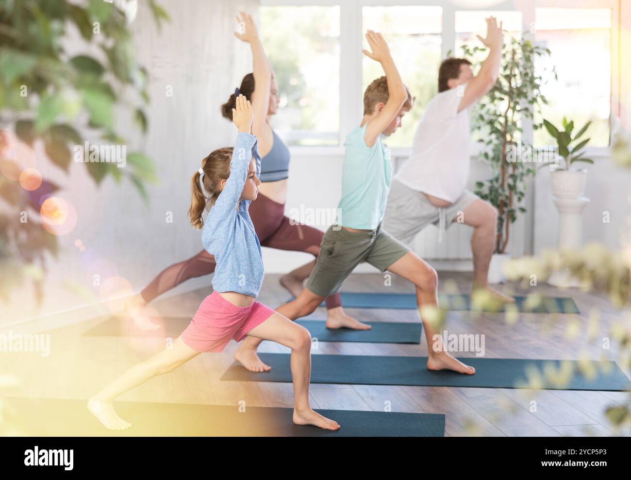 Family with two children doing pilates in studio Stock Photo - Alamy