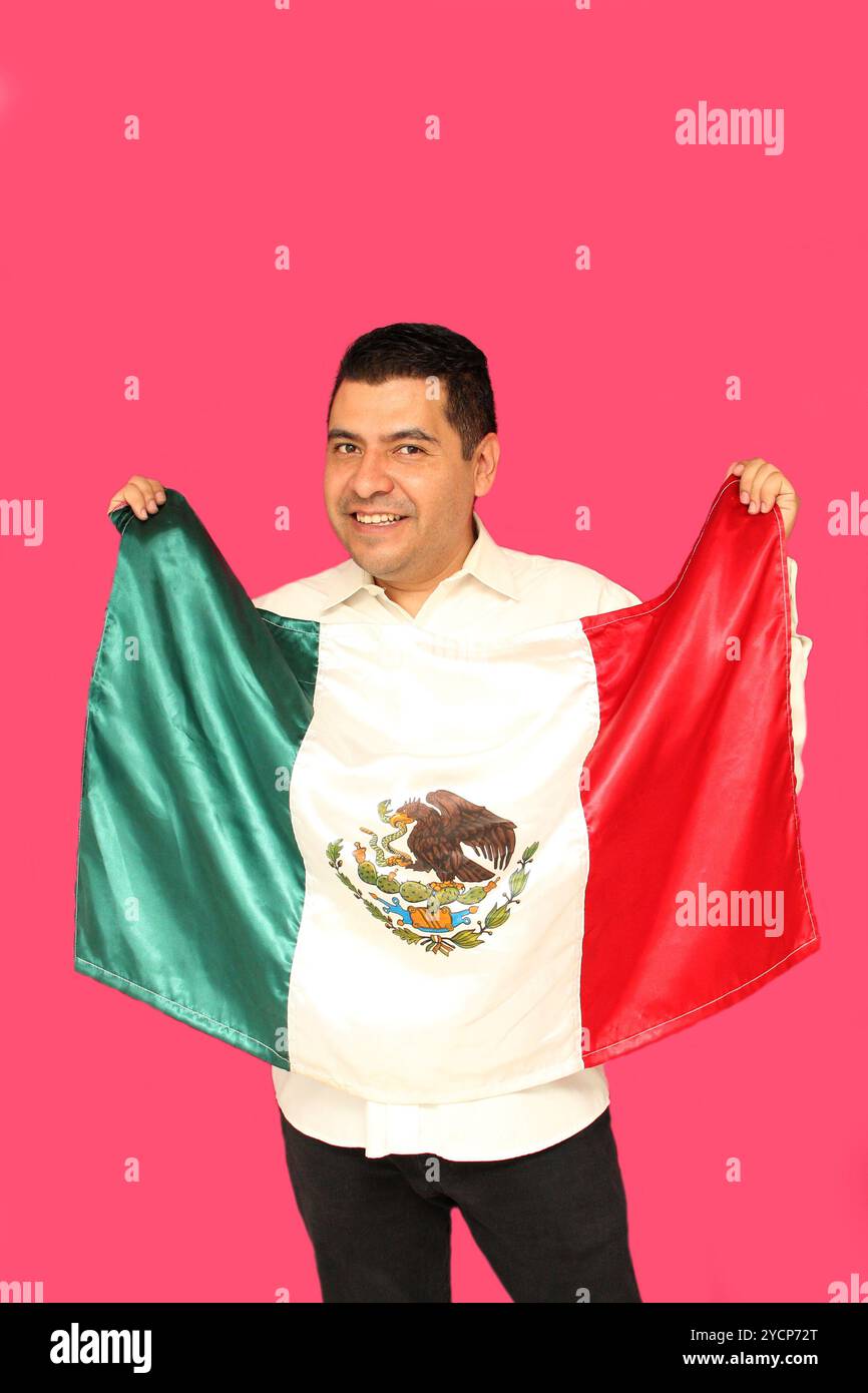 40-year-old dark-skinned Mexican man proudly shows the flag of Mexico ...