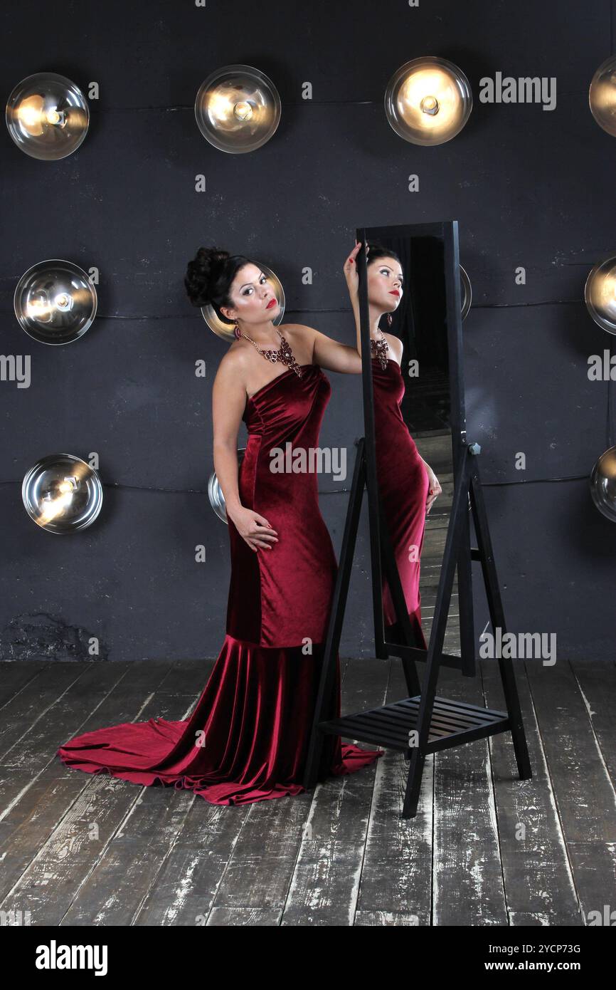 Lady in red and magic mirror on stage Stock Photo - Alamy