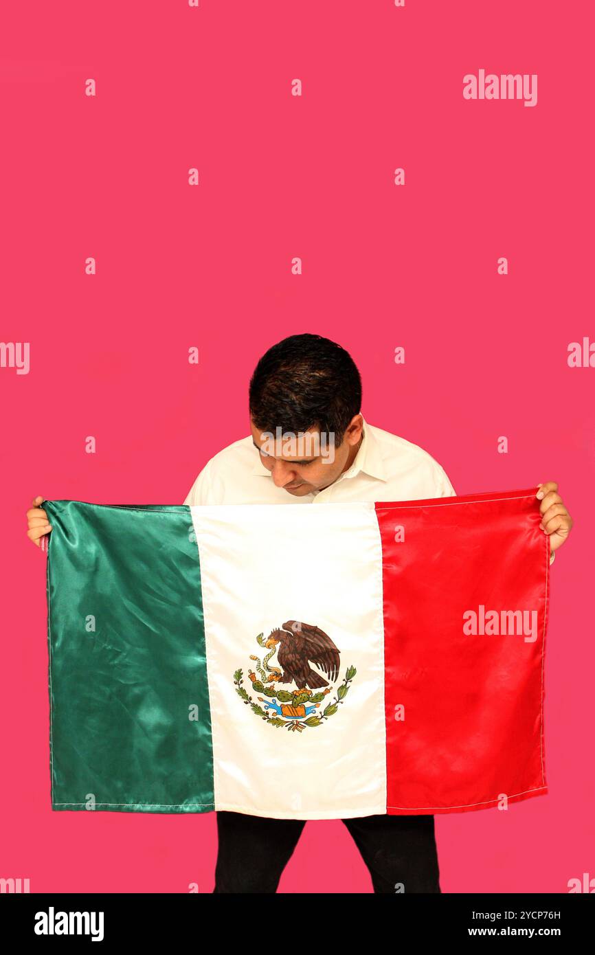 40-year-old dark-skinned Mexican man proudly shows the flag of Mexico ...