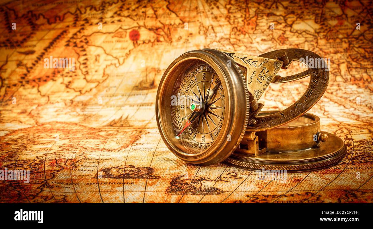 Vintage compass lies on an ancient world map Stock Photo - Alamy