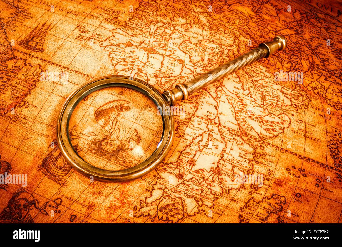 Vintage magnifying glass lies on an ancient world map Stock Photo - Alamy