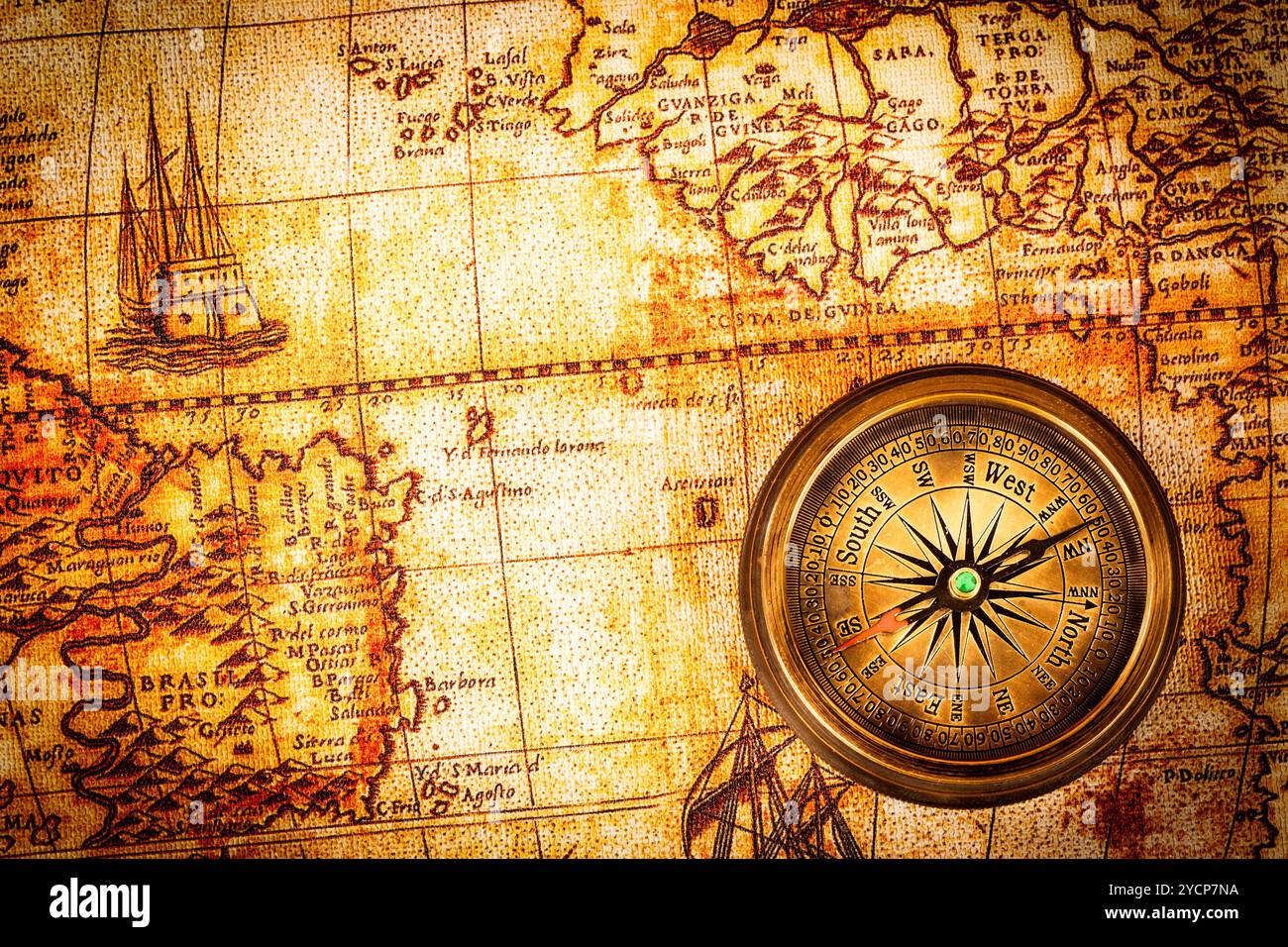 Vintage compass lies on an ancient world map Stock Photo - Alamy
