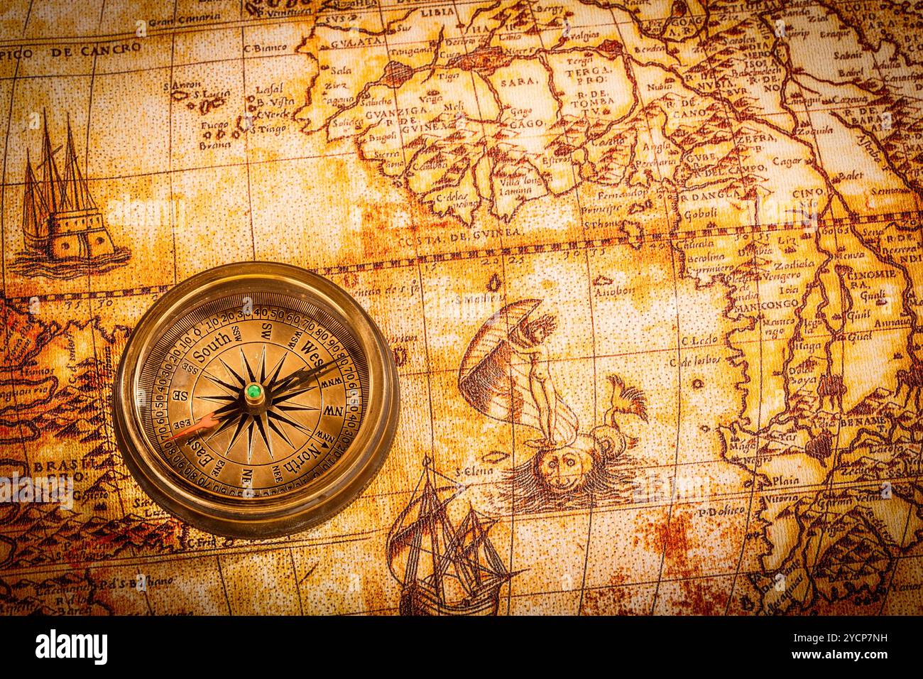 Vintage compass lies on an ancient world map Stock Photo - Alamy