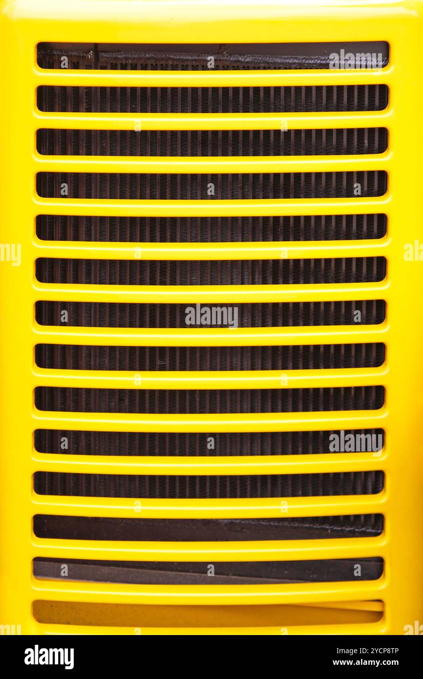 Yellow radiator cooling grill at construction machine Stock Photo - Alamy