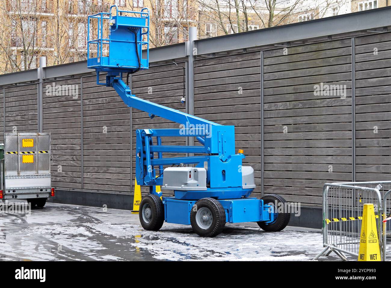 Articulating blue boom lift for construction work Stock Photo - Alamy