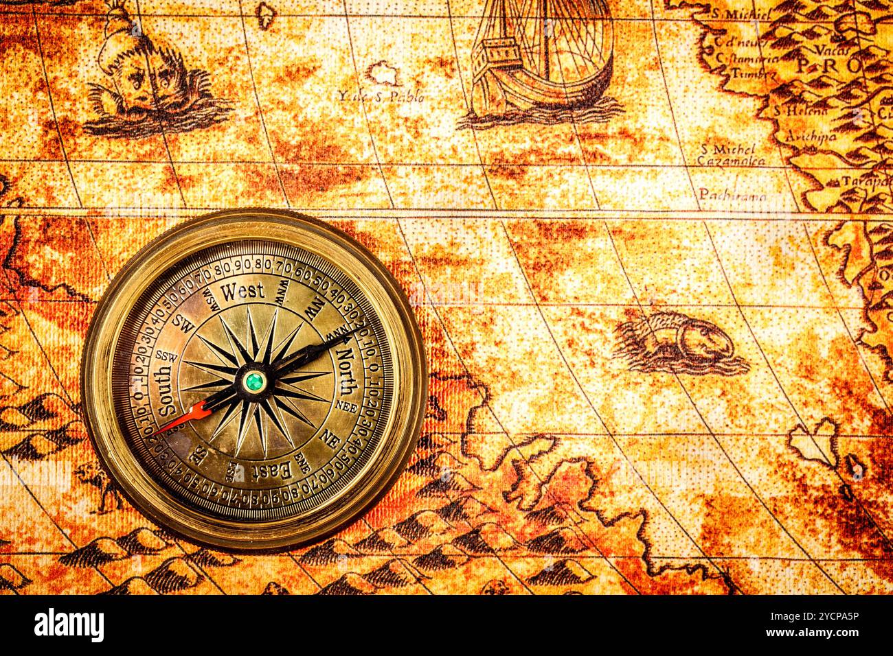 Vintage compass lies on an ancient world map Stock Photo - Alamy