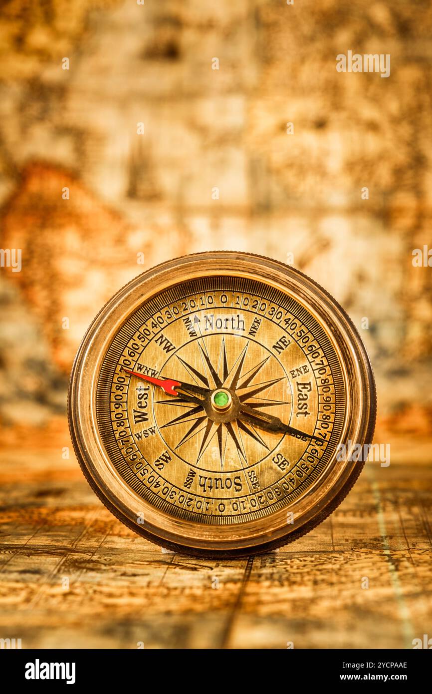 Vintage compass lies on an ancient world map Stock Photo - Alamy