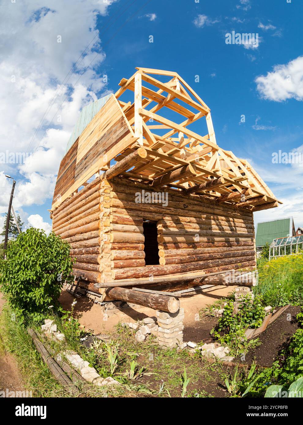 Construction of a new wooden house in summertime Stock Photo - Alamy