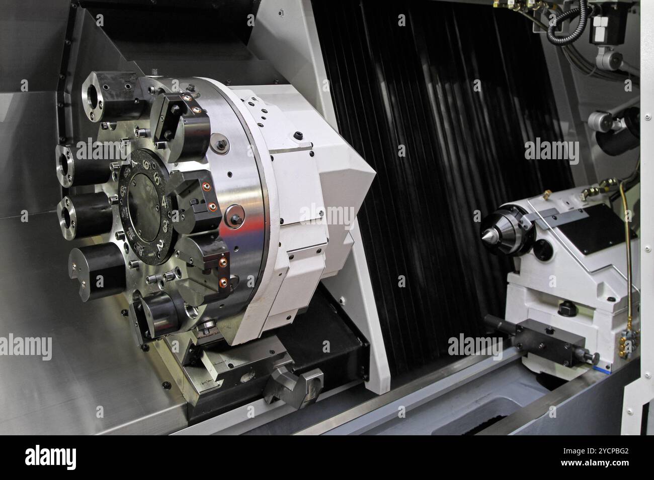 Rotating head at CNC lathe in workshop Stock Photo - Alamy