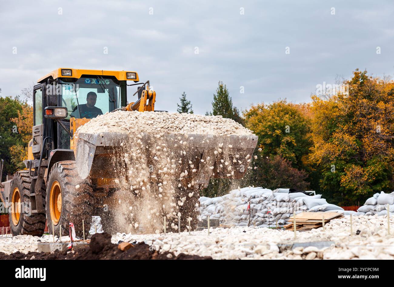 Heavy bulldozer loading and moving gravel on road Stock Photo - Alamy