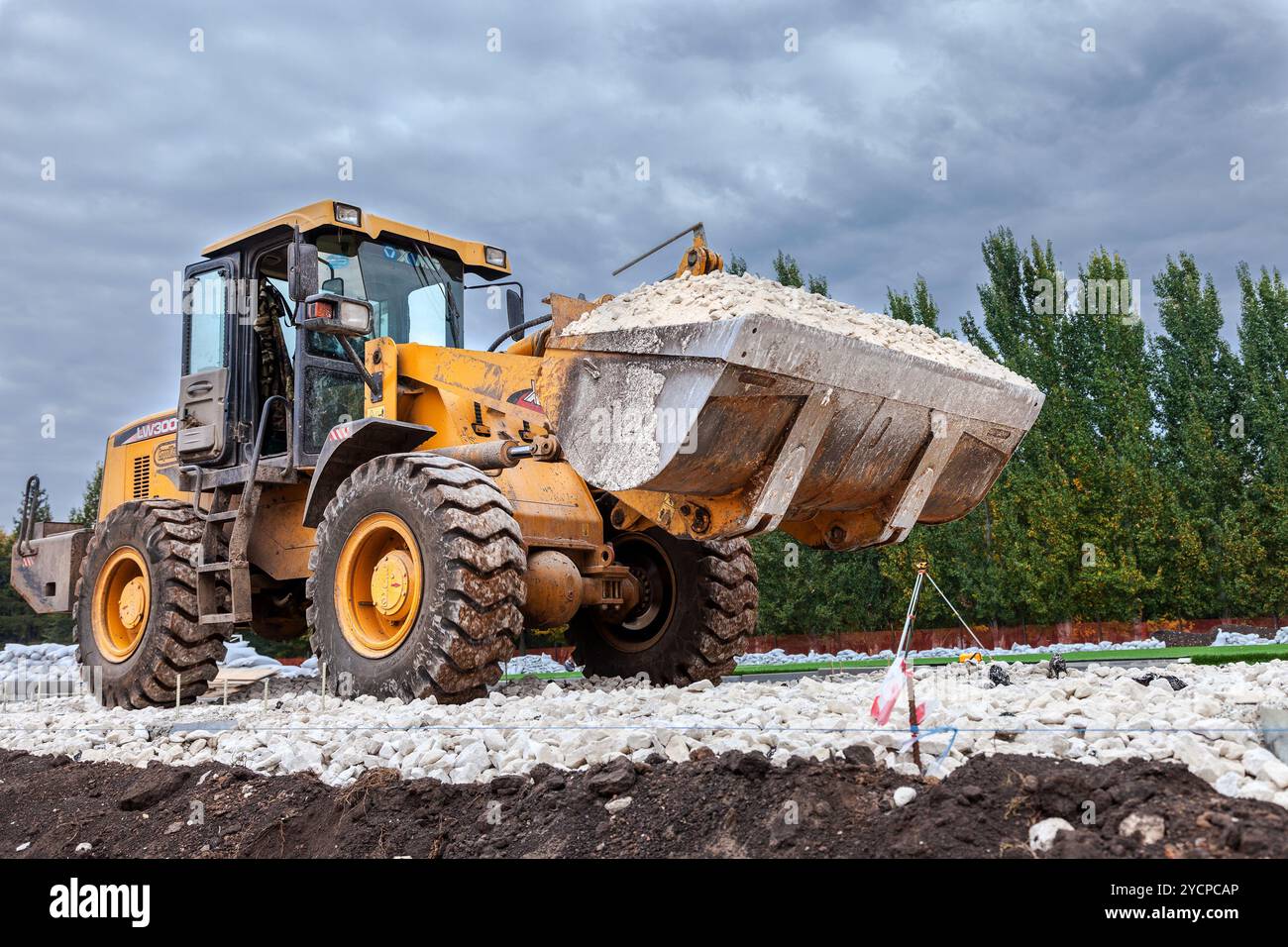 Heavy bulldozer loading and moving gravel on road Stock Photo - Alamy
