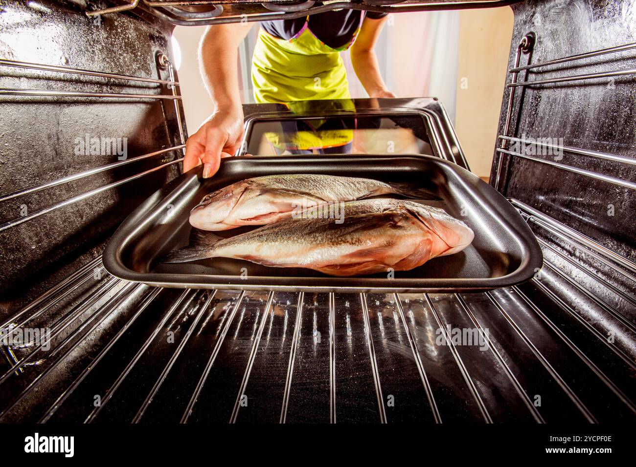 Cooking Dorado fish in the oven Stock Photo - Alamy