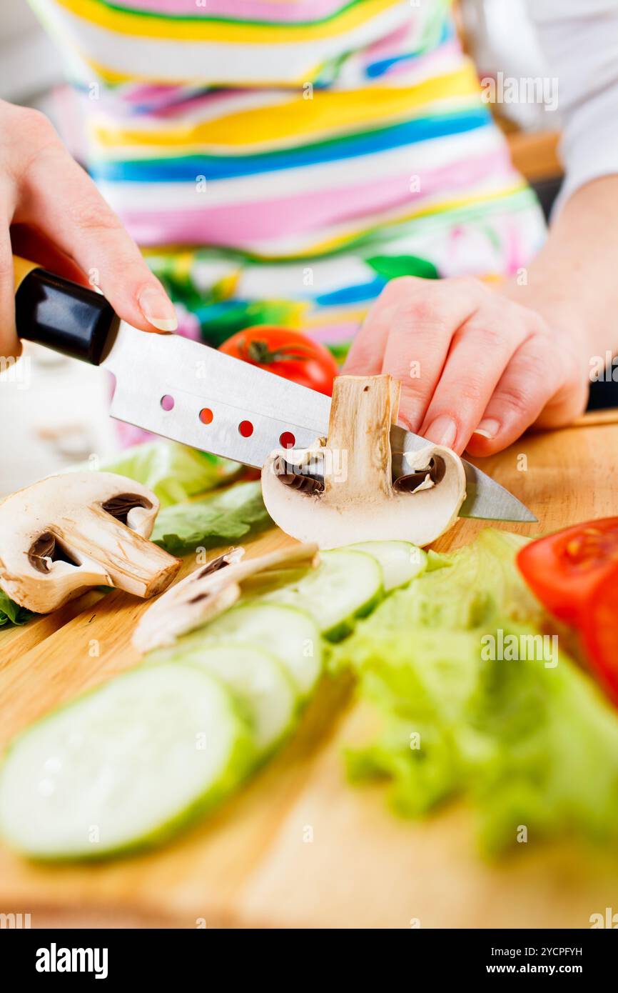 Cutting mushroom champignon Stock Photo - Alamy