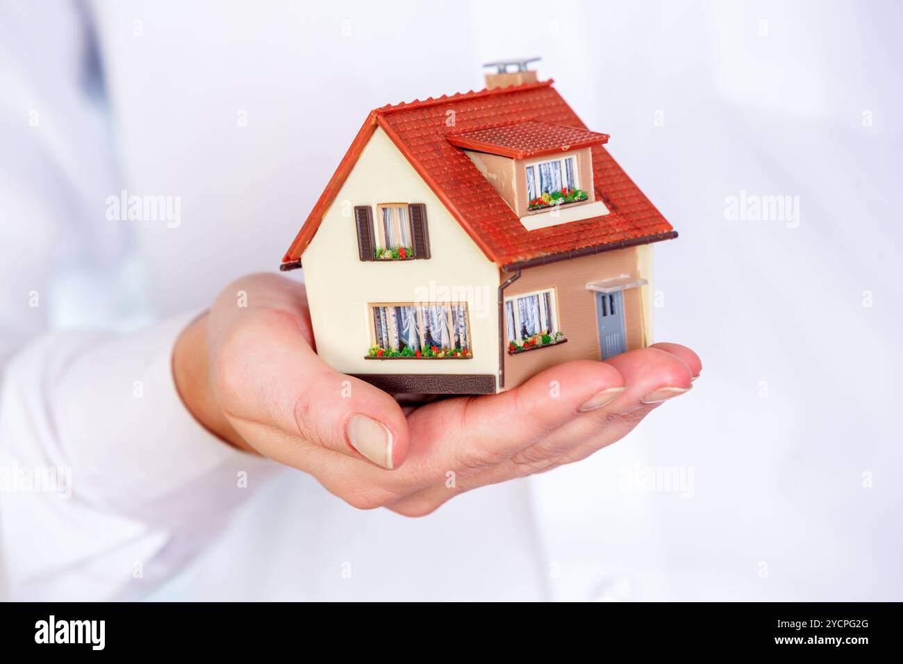 House in human hands Stock Photo - Alamy