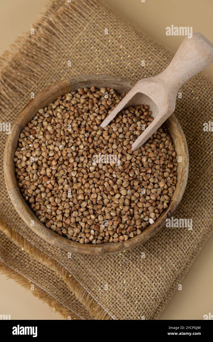 Raw buckwheat porridge in neutral beige background copy space. Whole ...