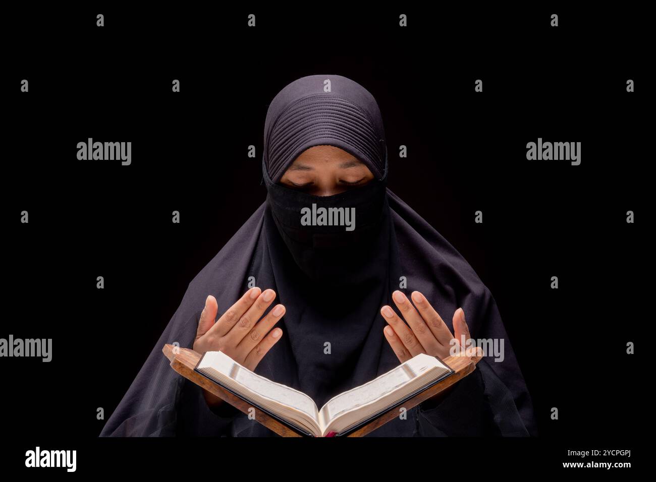 Portrait Asian Muslim woman standing and reading the Quran and ...