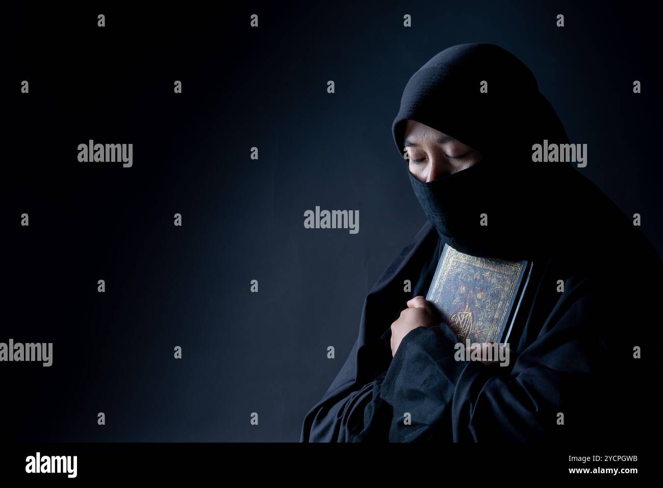 Portrait Asian Muslim woman standing and reading the Quran and ...