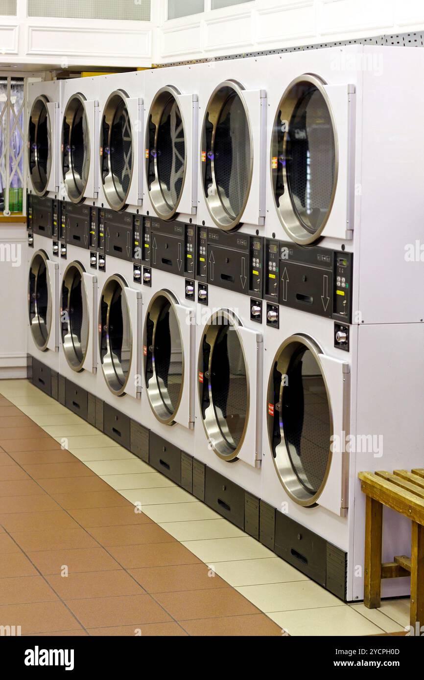 A row of industrial washing machines in laundry shop Stock Photo - Alamy
