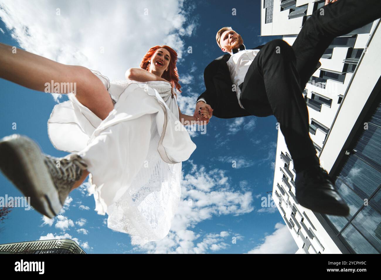 Wedding couple jumping Stock Photo - Alamy