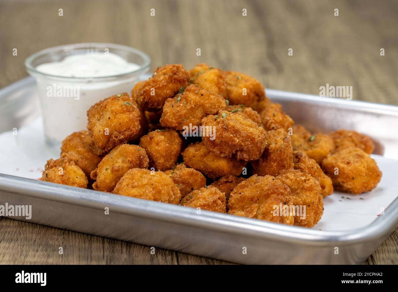 Crispy order of popcorn chicken nuggets on a tray with ranch dipping ...