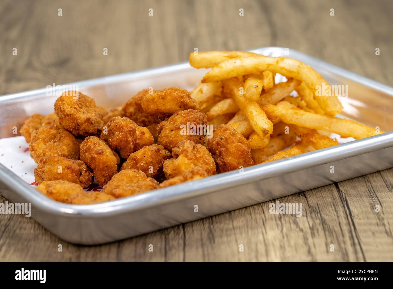 Crispy combination order of breaded popcorn chicken and french fries on ...
