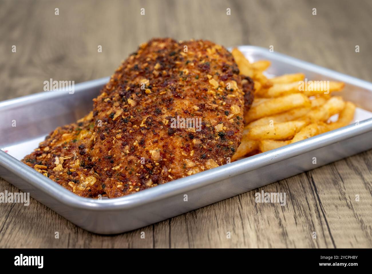 Crispy order of seasoned fish fillet of tilapia and french fries on a ...