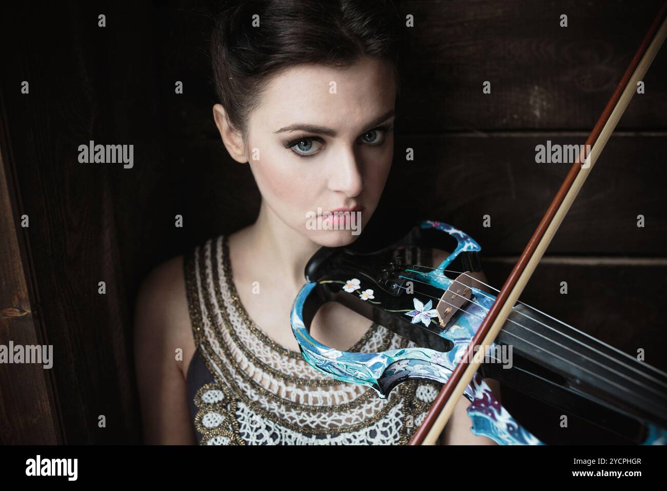 girl posing in the room by the window, holding a violin Stock Photo - Alamy