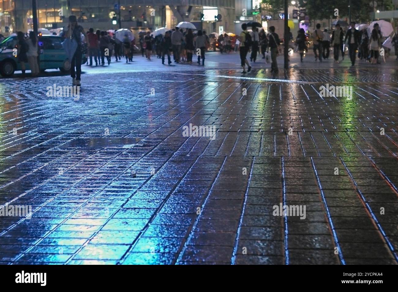 rainy pavement reflection by night with crowd apart in Tokyo Metropolis ...