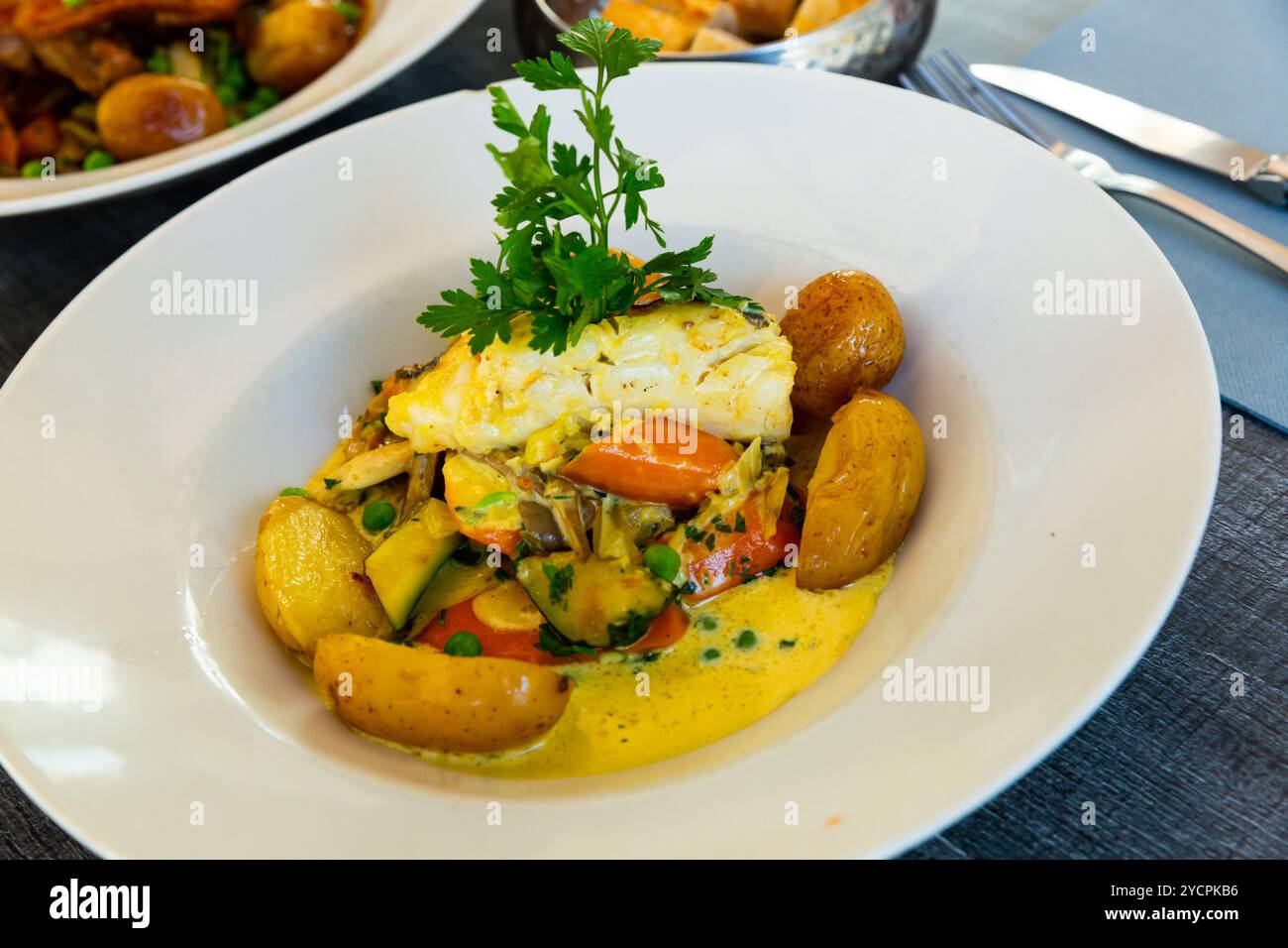 Hake fillet in Spanish style Stock Photo - Alamy