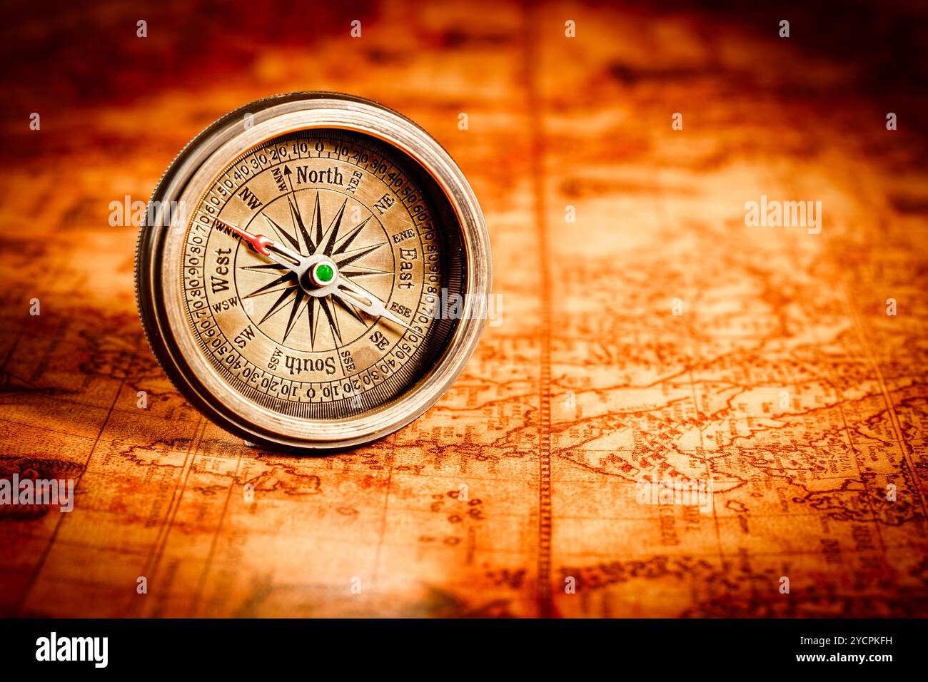 Vintage compass lies on an ancient world map Stock Photo - Alamy