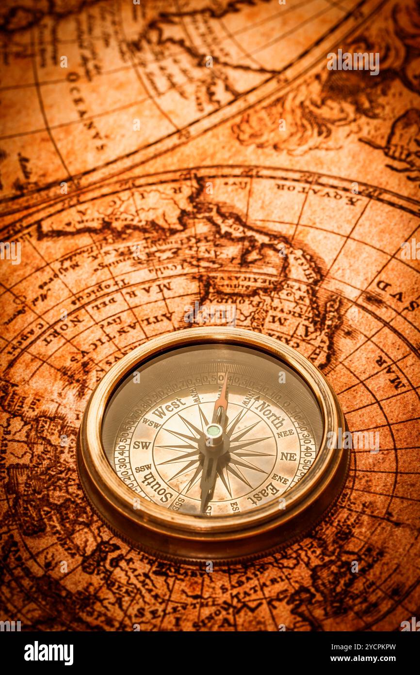 Vintage compass lies on an ancient world map Stock Photo - Alamy