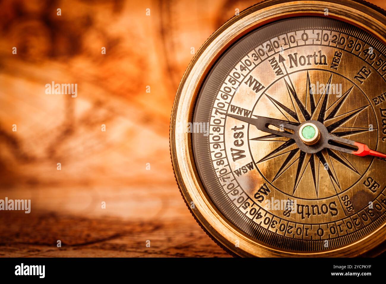Vintage compass lies on an ancient world map Stock Photo - Alamy