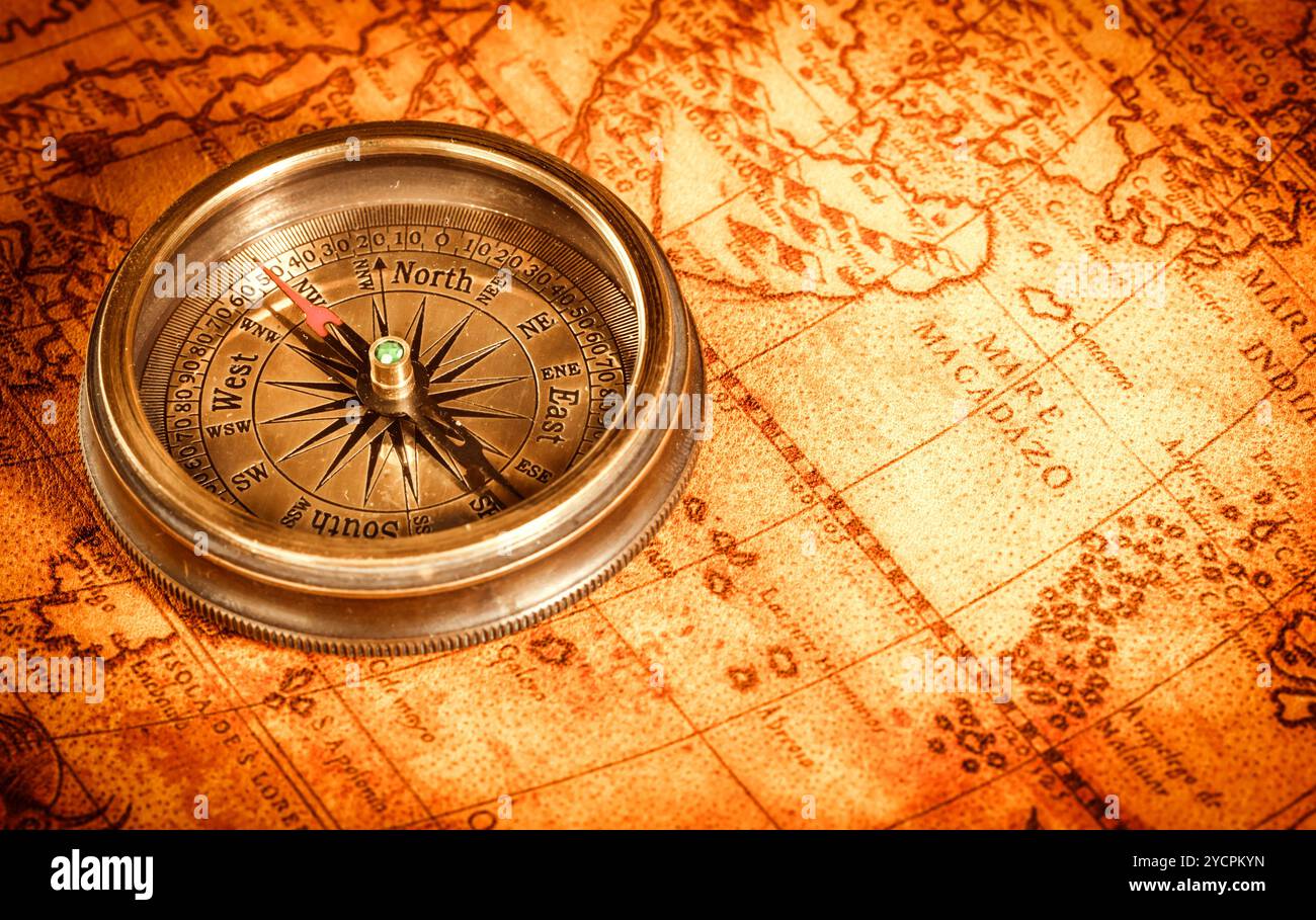 Vintage compass lies on an ancient world map Stock Photo - Alamy