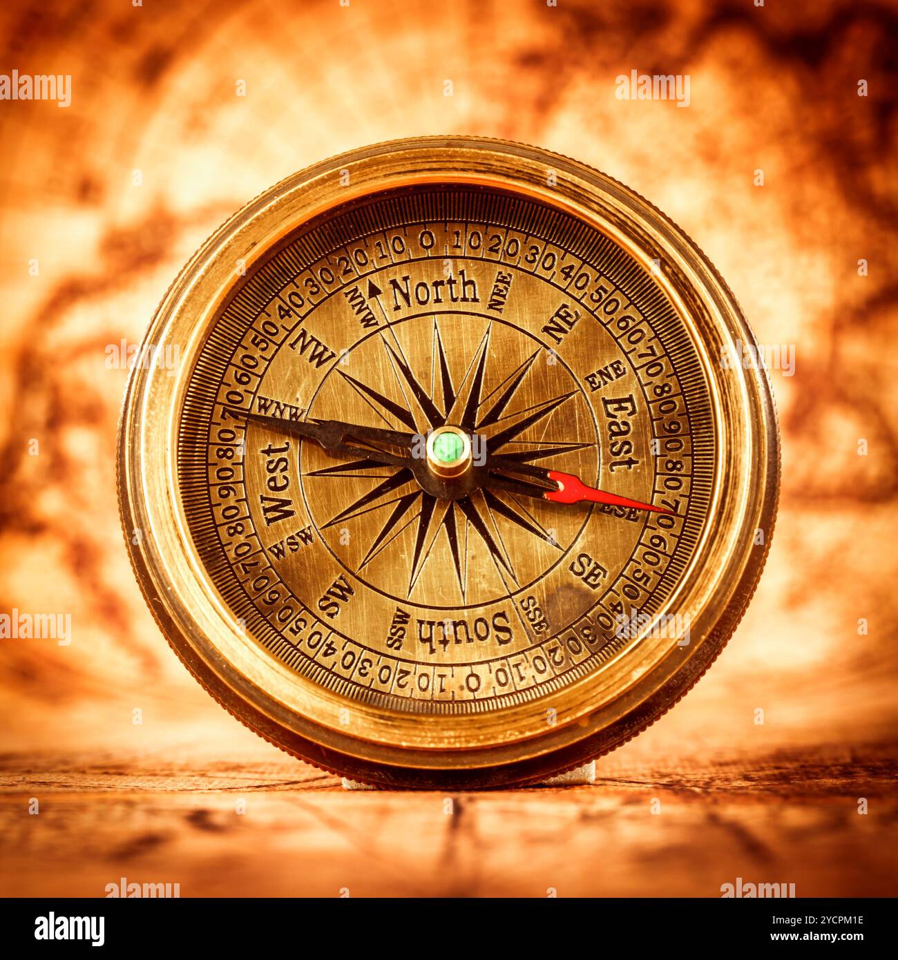 Vintage compass lies on an ancient world map Stock Photo - Alamy